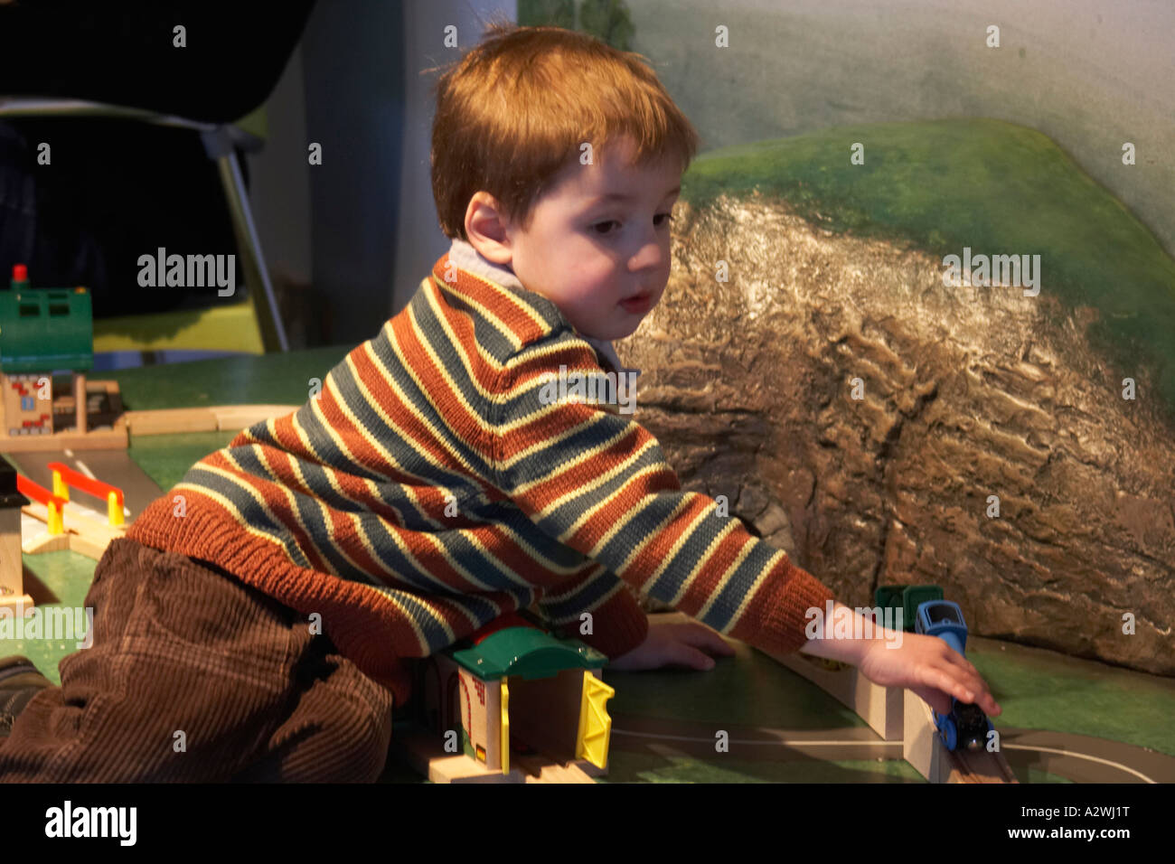 Young boy child playing with model railway toy in Odyssey W5 ...