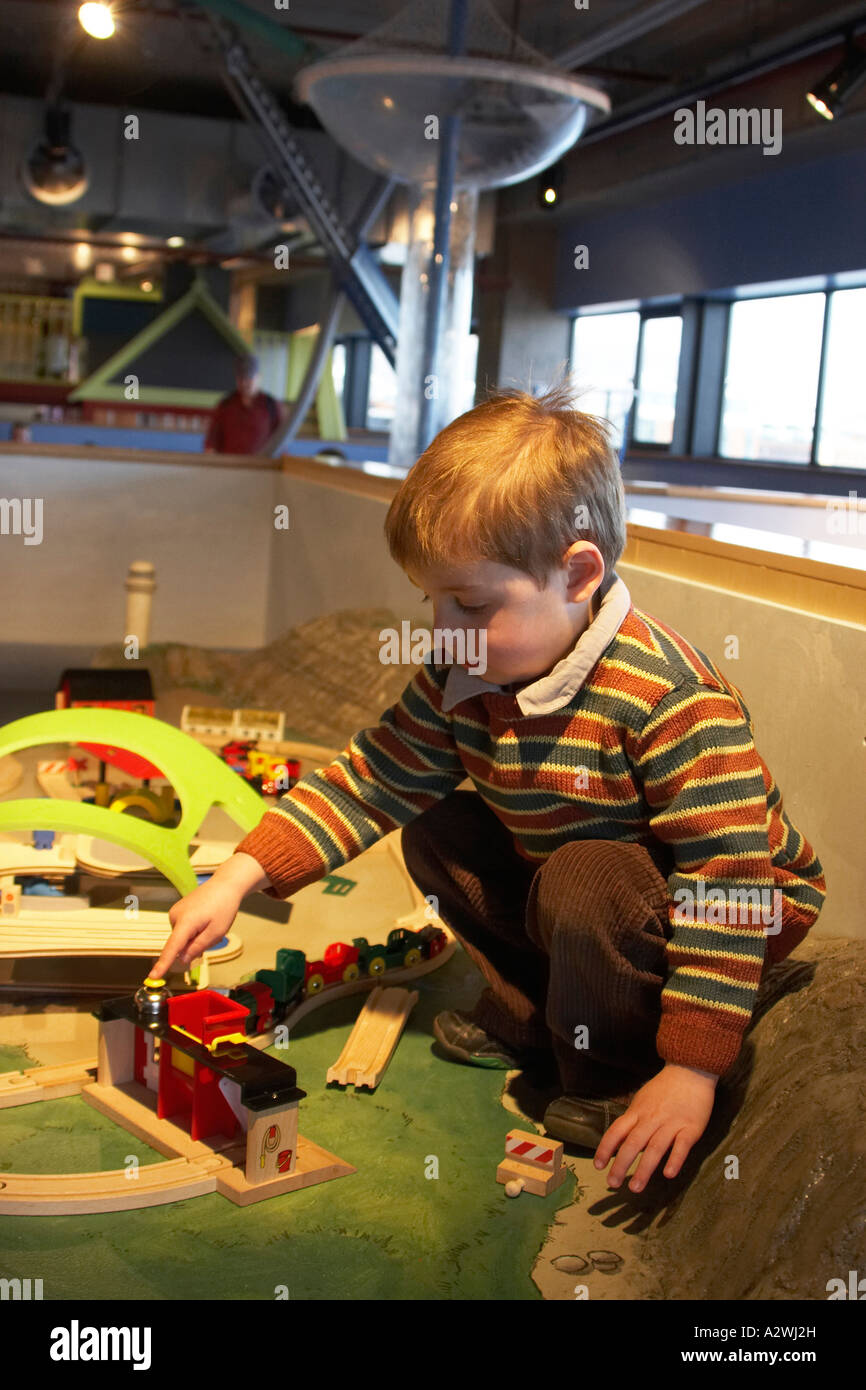 Young boy child playing with model railway toy in Odyssey W5 ...