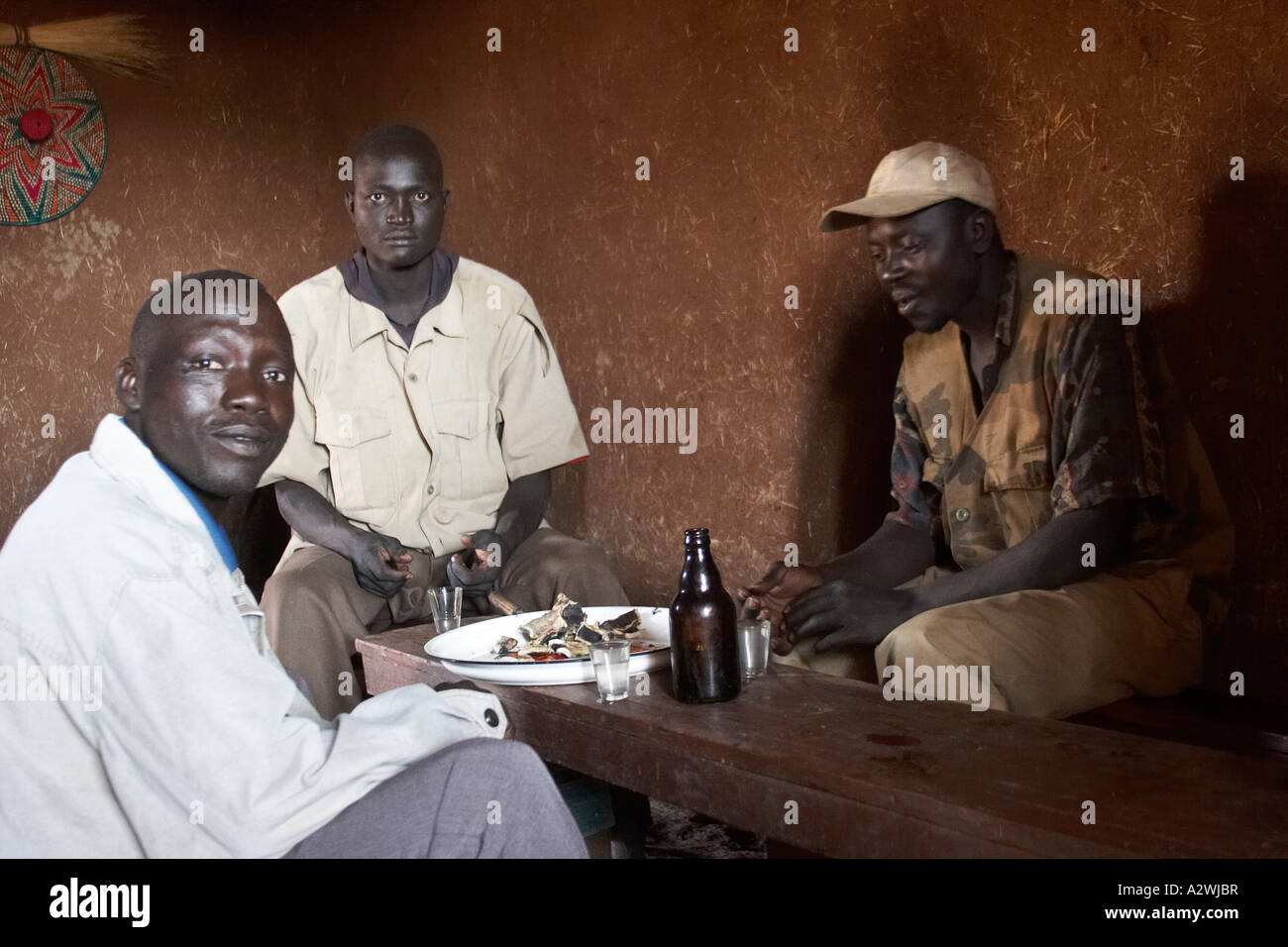 Men in a cafe eating dish of meat in village near Mendi western ...