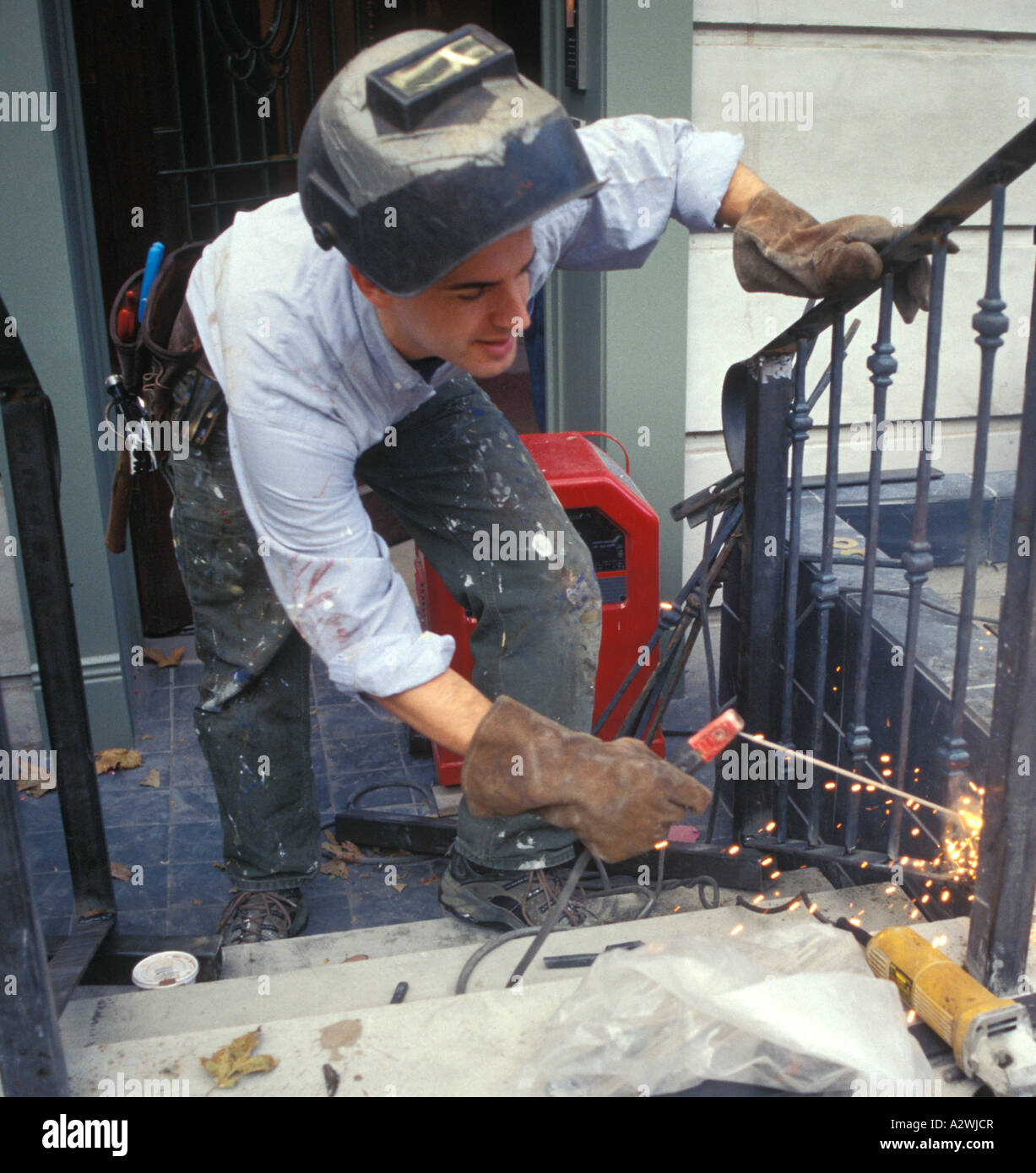 Young man welding banister Stock Photo - Alamy