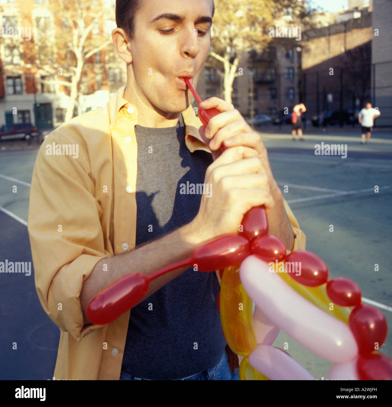 Man blowing up balloons hi-res stock photography and images - Alamy