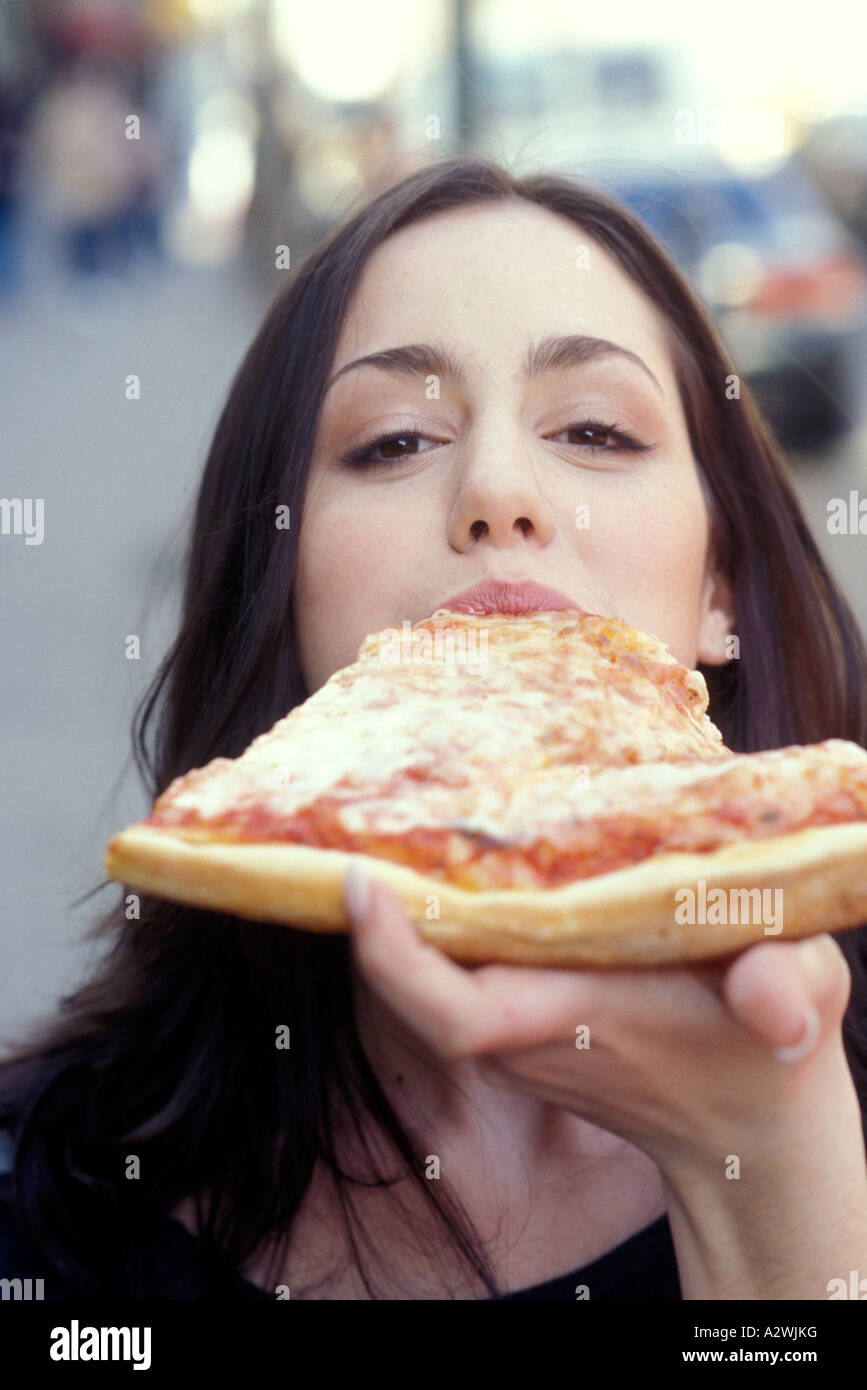 Woman eating pizza, portrait Stock Photo - Alamy