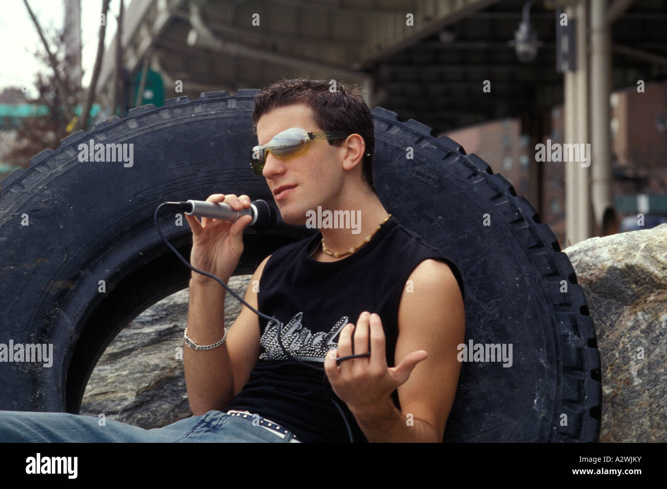 Young man holding mike Stock Photo - Alamy