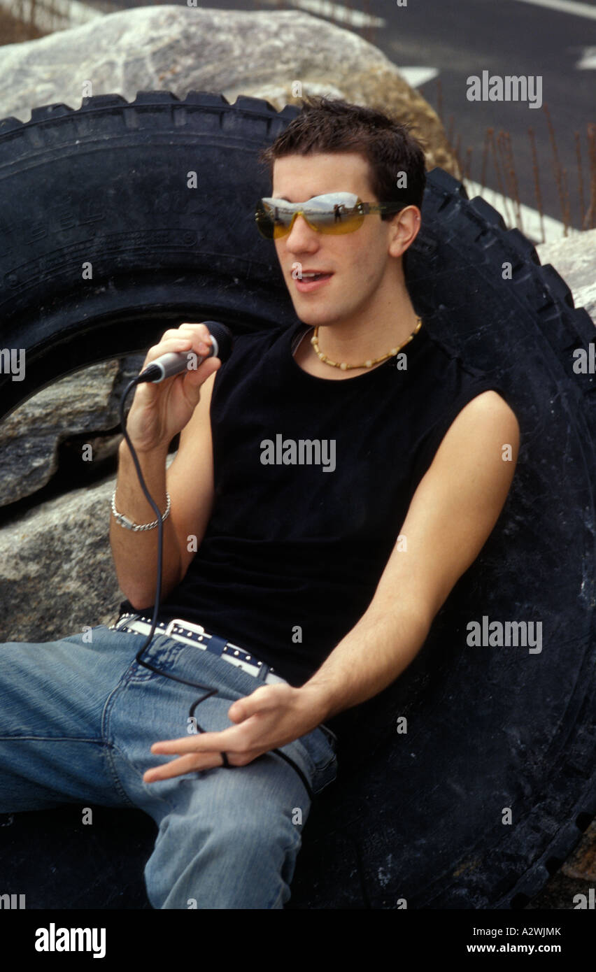 Young man holding mike Stock Photo - Alamy