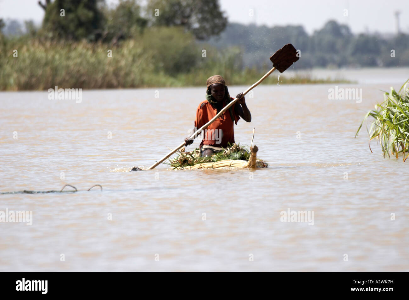 Woman paddling reed boat hi-res stock photography and images - Alamy