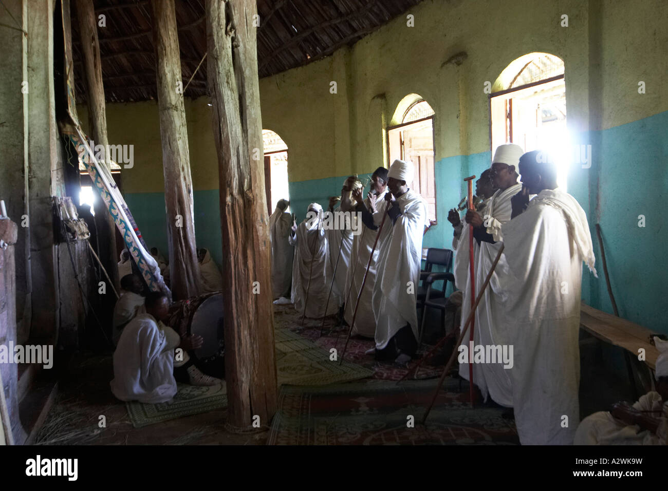 Priests chanting and singing mass with boys playing drums in 14C Debre ...