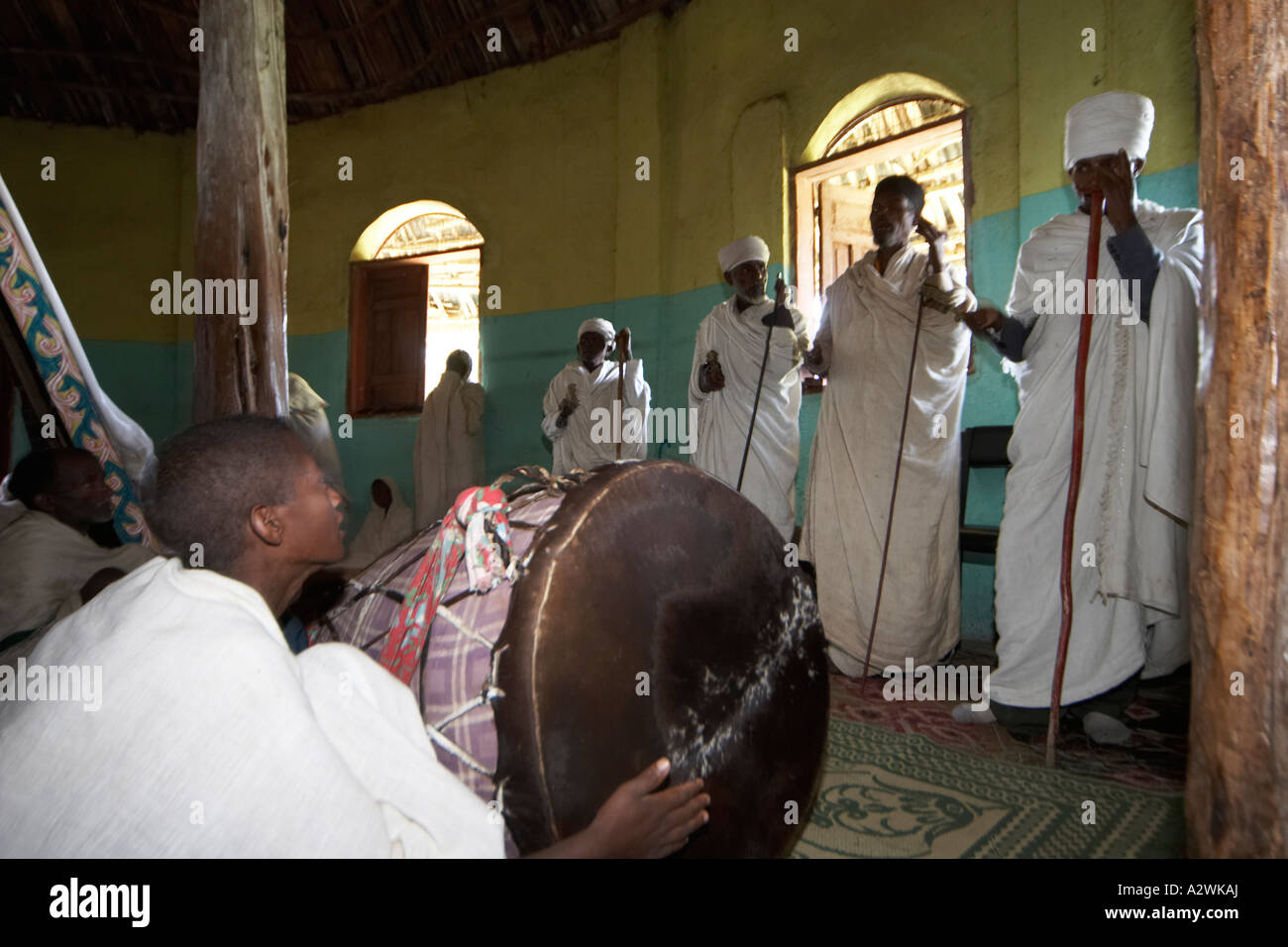Priests chanting and singing mass with boys playing drums in 14C Debre ...