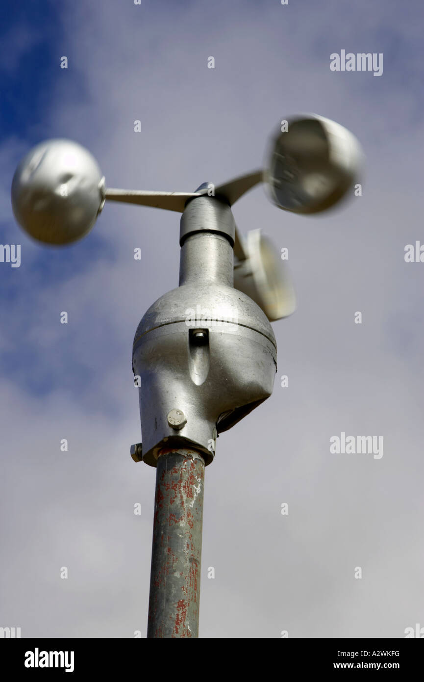 Anemometer in motion for monitoring wind speed against a blue cloudy ...