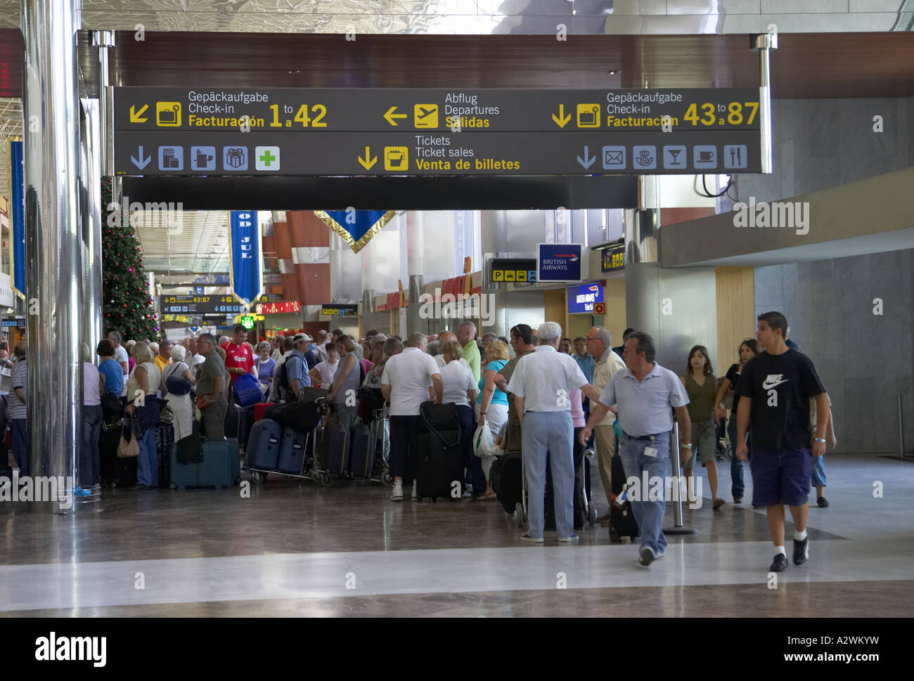 tourists queuing up in check in departures area of Reina Sofia Sur TFS ...