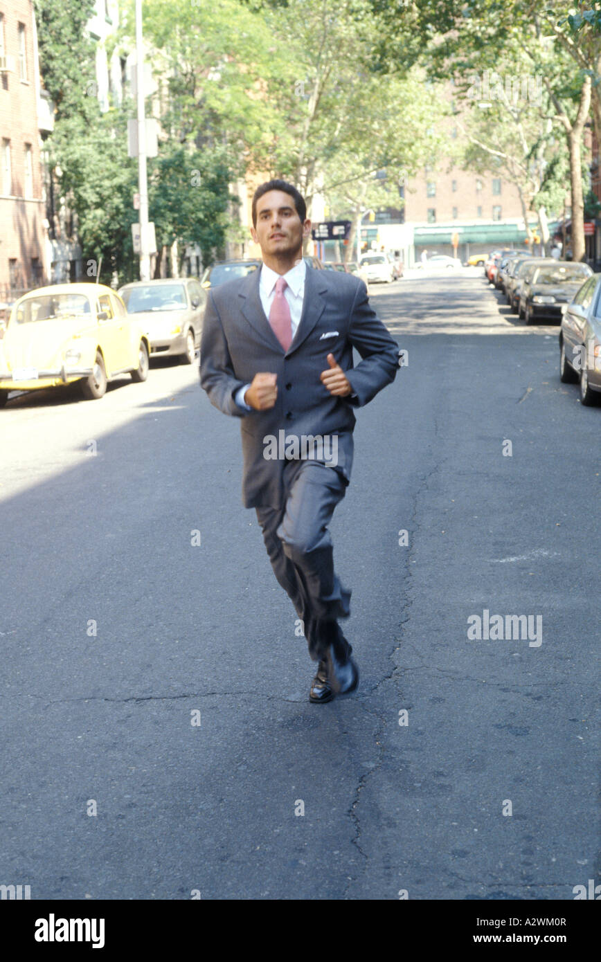 Businessman running on street, portrait Stock Photo - Alamy