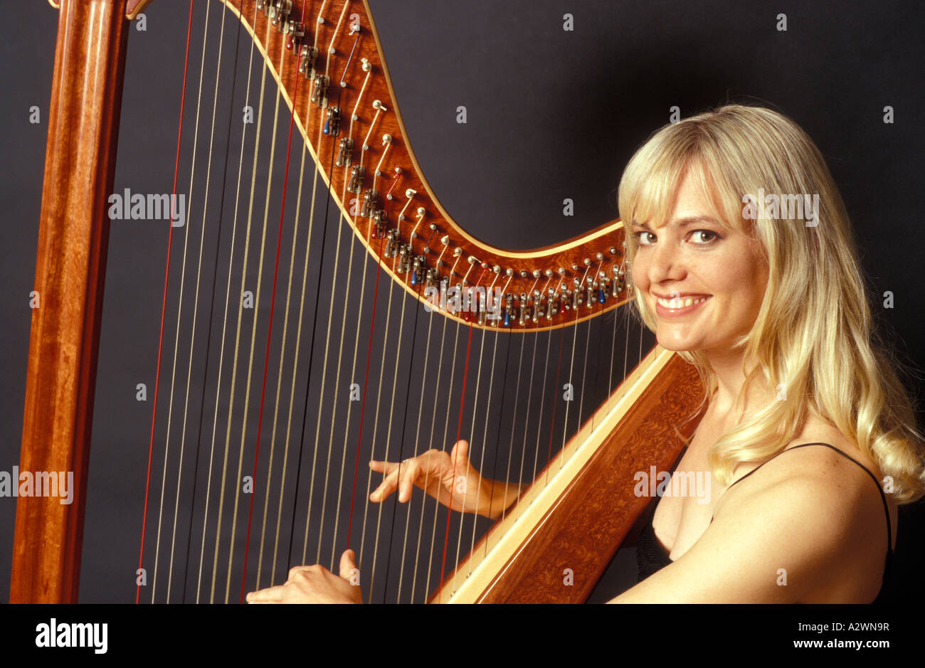 Black female playing harp hi-res stock photography and images - Alamy