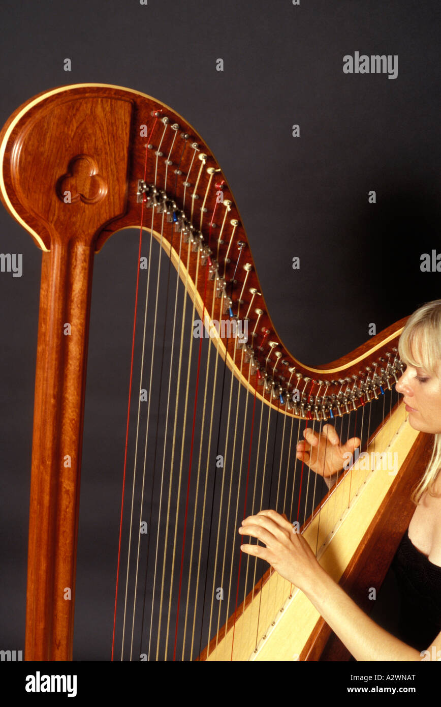 Young woman playing harp Stock Photo - Alamy