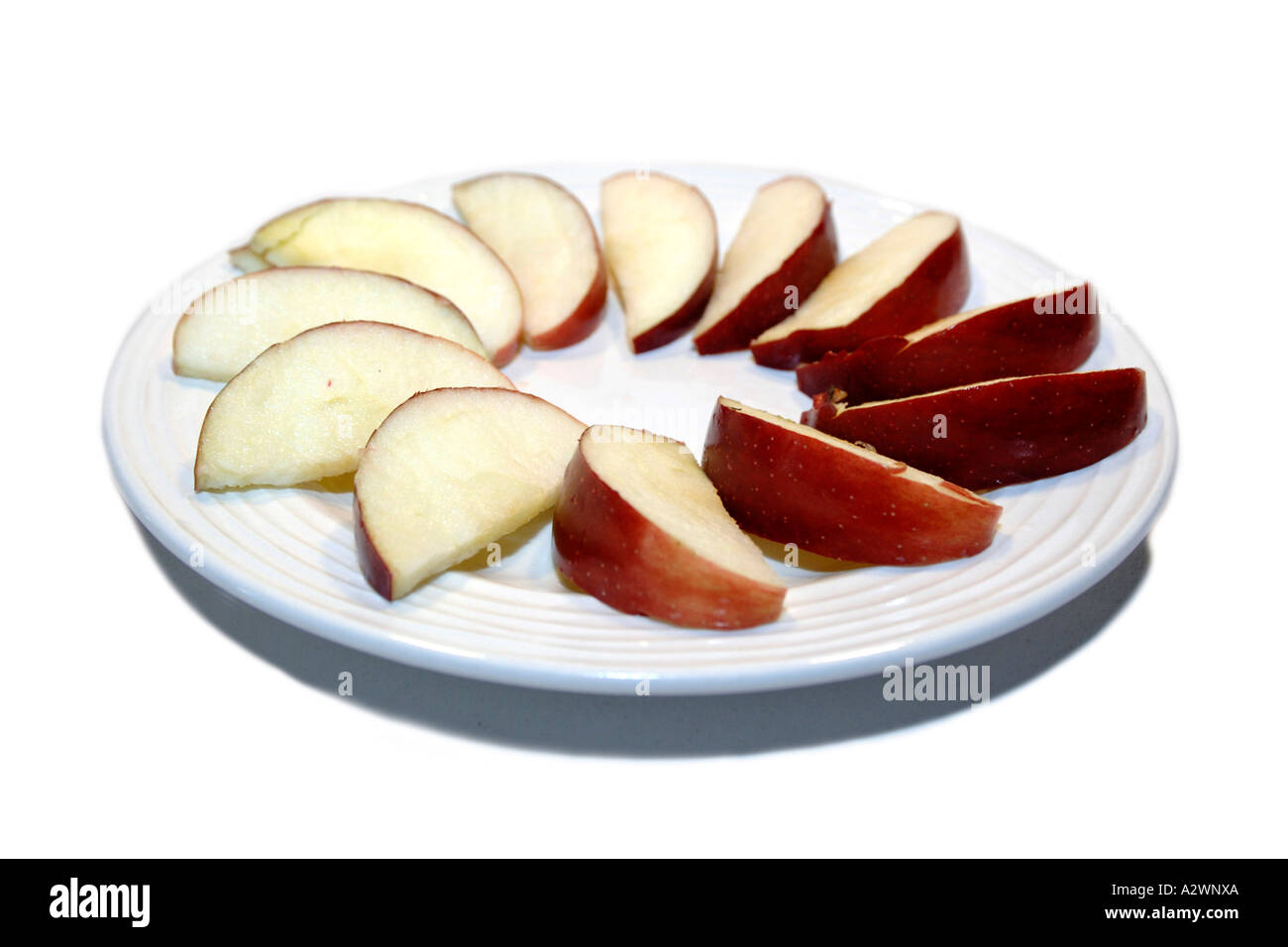 A Red apple cut into segments on a white Stock Photo - Alamy