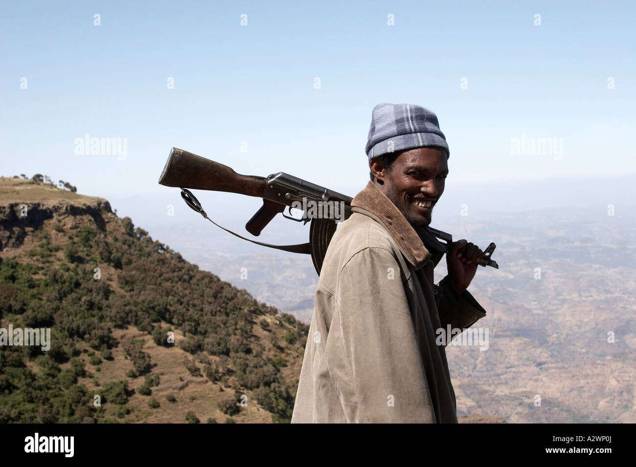 Security guard with rifle gun on escarpment cliffs in Simien Mountains ...