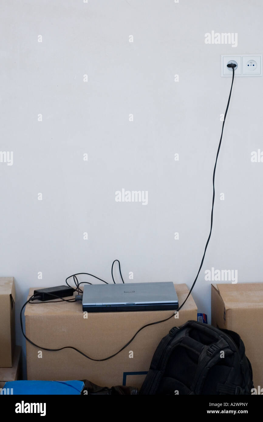 Extension cord pulling out of electric outlet. Laptop computer Stock ...