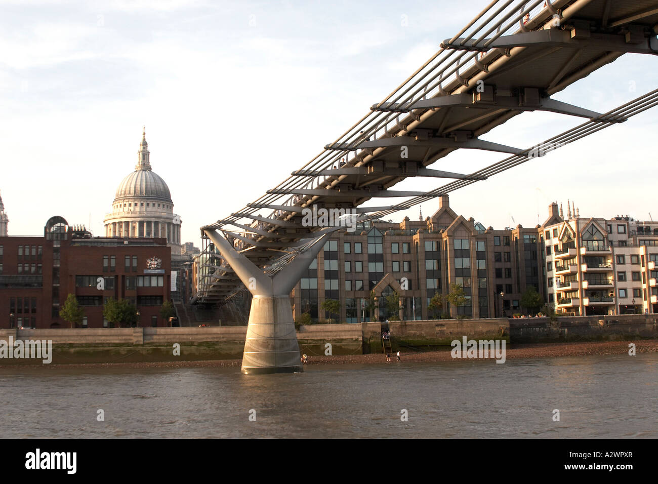 Millenium Bridge from River Thames below in evening sunlight with ...