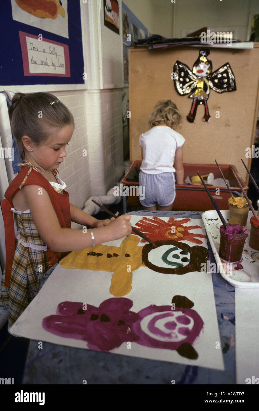 children painting primary school art lesson Stock Photo - Alamy