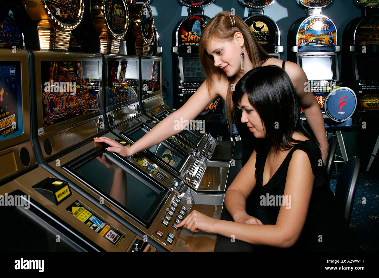 Girl playing fruit machine hi-res stock photography and images - Alamy