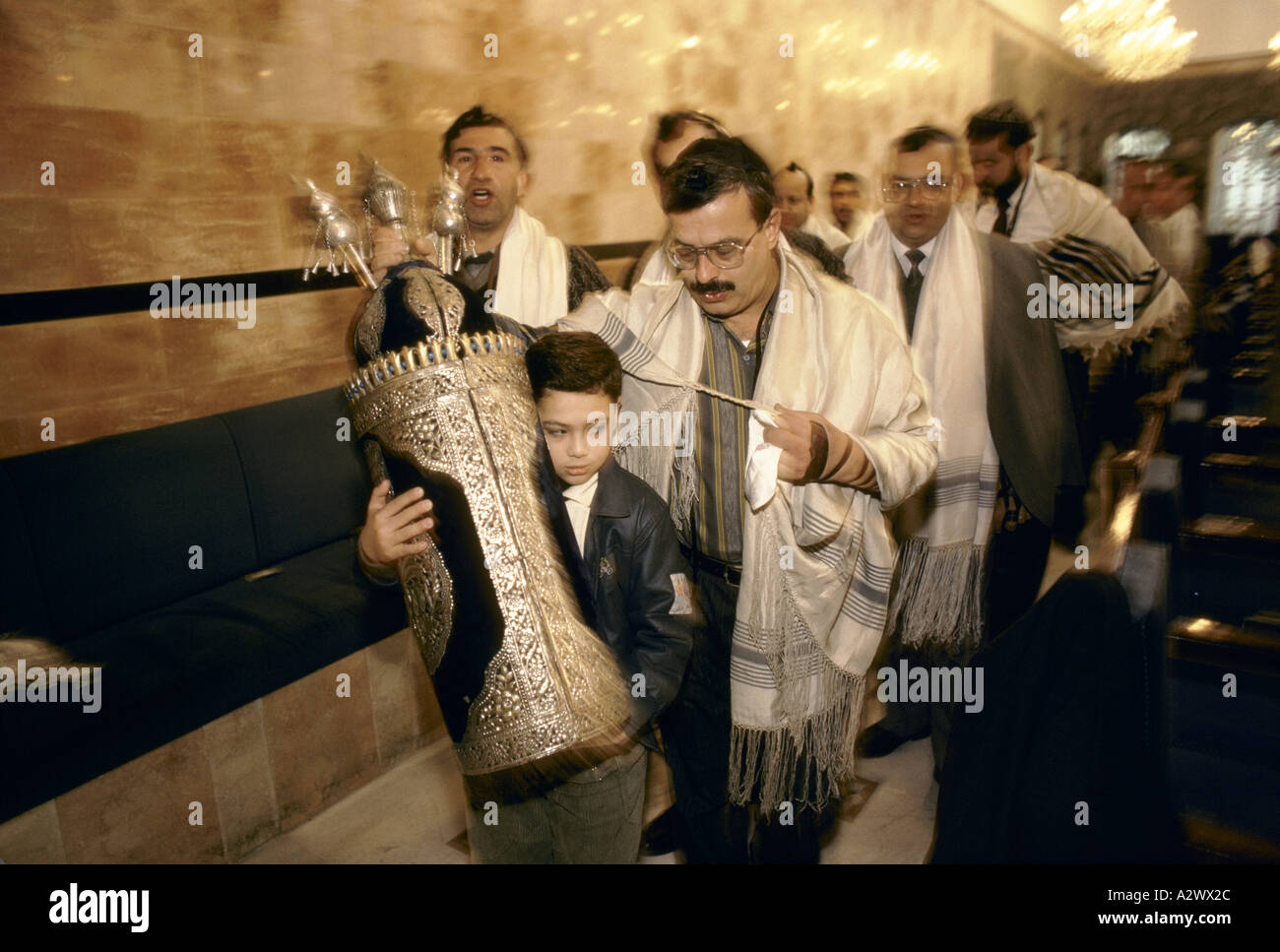 A boy carries the torah at his bar mitzvah in the synagogue of the ...
