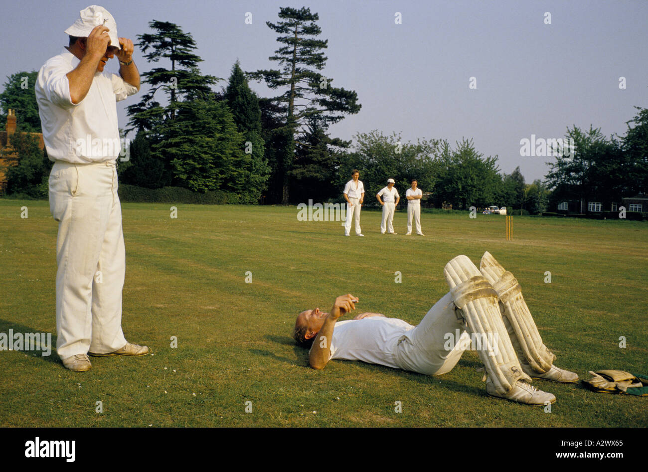 A cricketer relaxing during a village cricket match, UK Stock Photo - Alamy