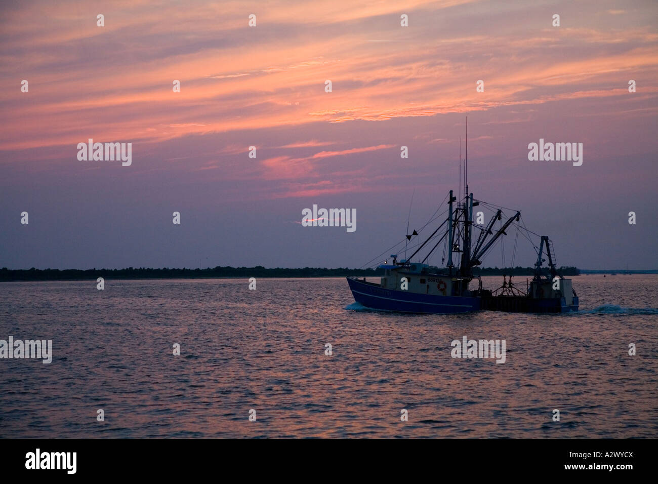 Fishing Boat in Sunset Stock Photo - Alamy