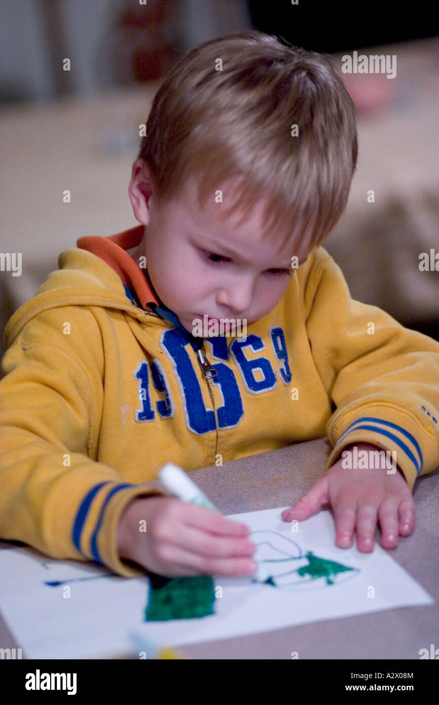 Boy age 5 intensely coloring a picture. Downers Grove Illinois IL USA ...