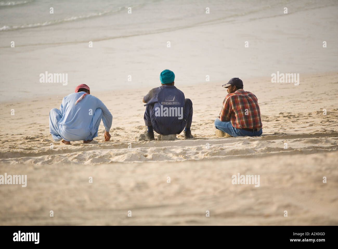 Construction workers take a break on the beach in Dubai, UAE Stock ...