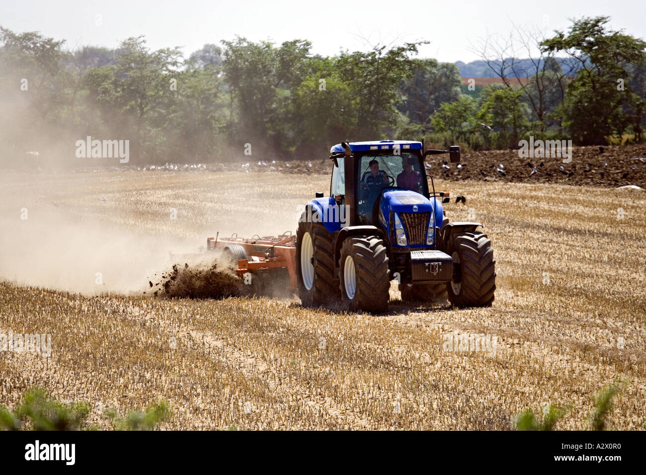 Large Farm Tractor And Plough Busy Ploughing Fields In Autumn Ready For ...