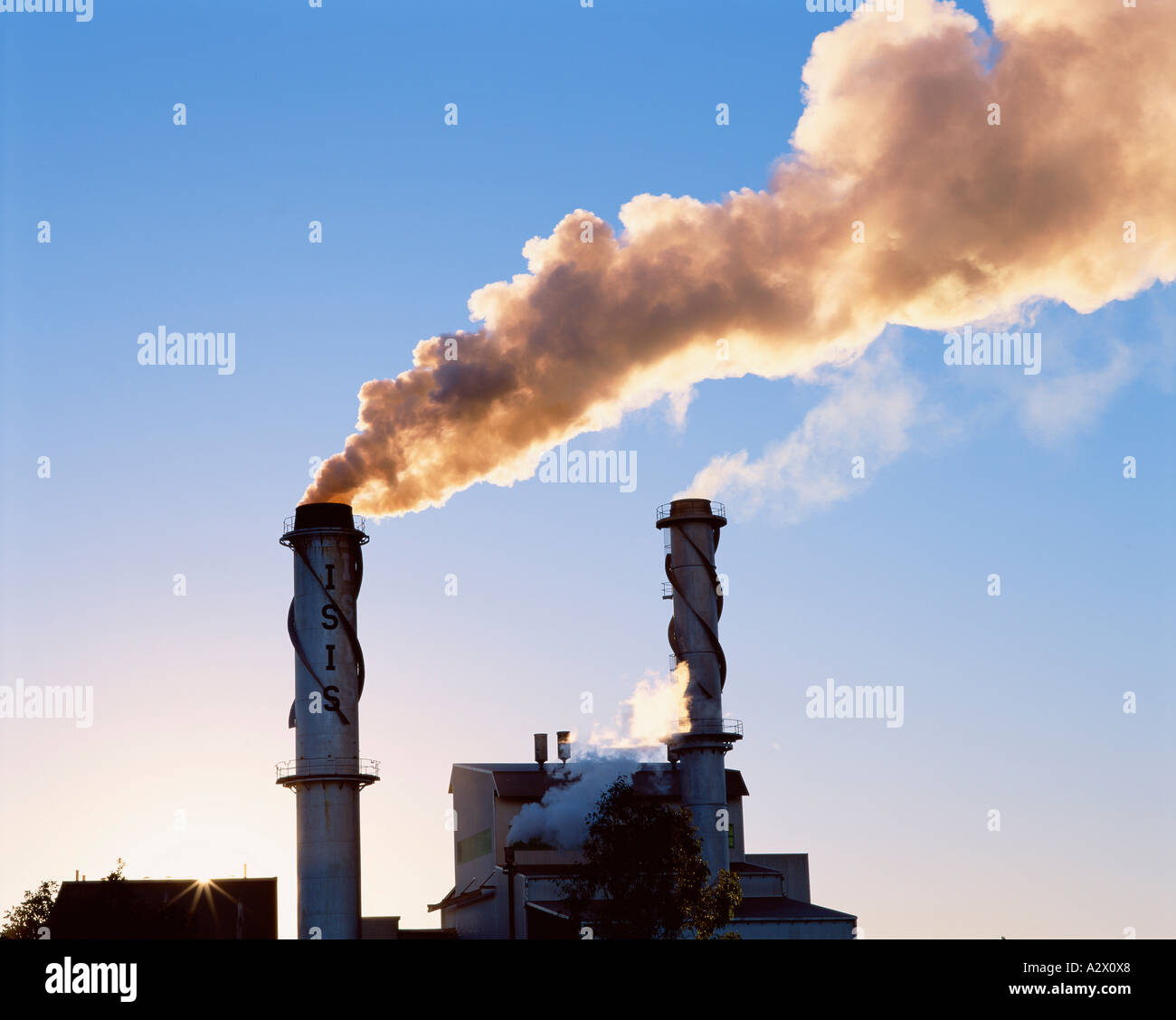 Australia. Queensland. Bundaberg sugar mill, smoking chimney stacks ...