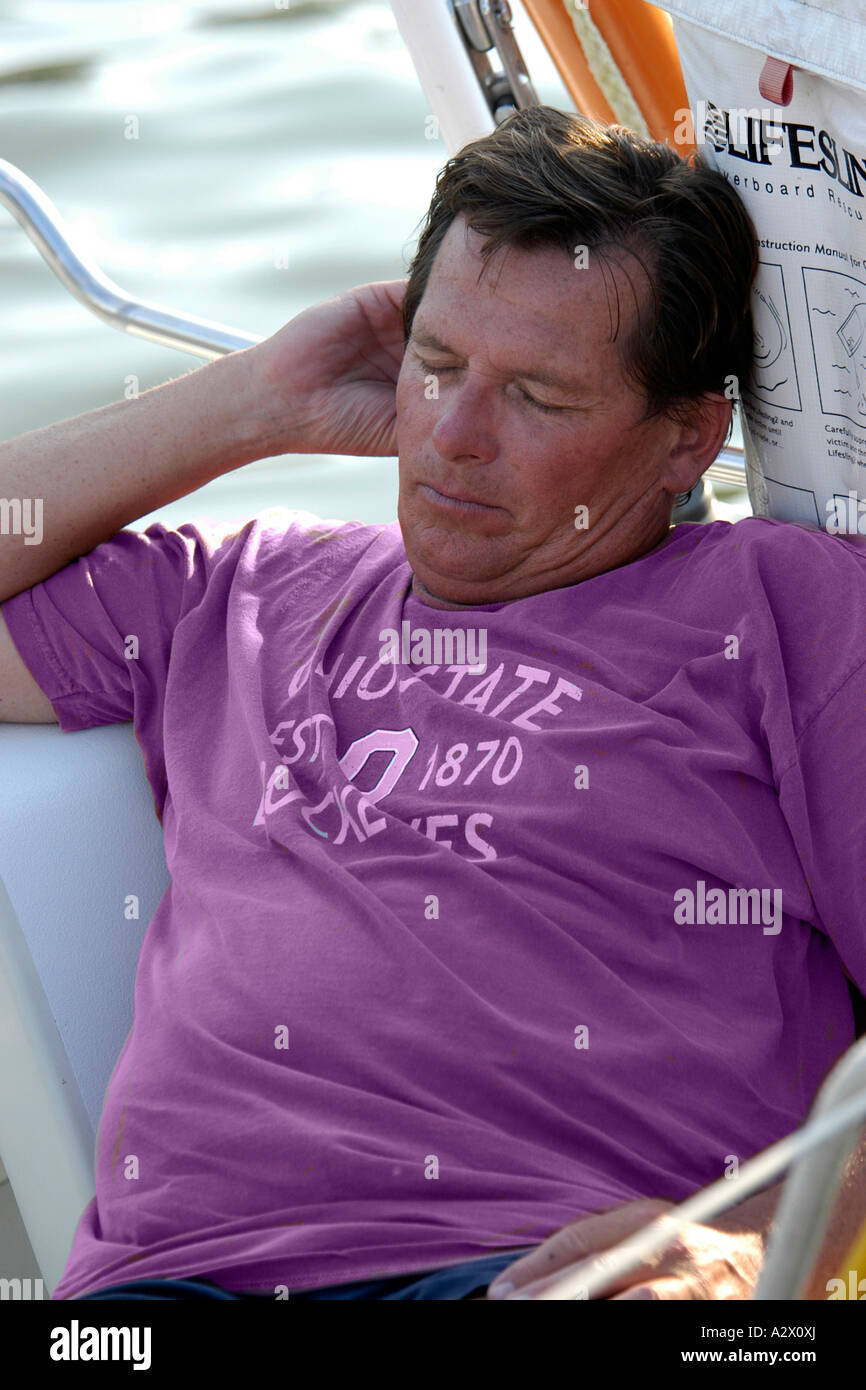 Adult male having a sleep aboard his boat Stock Photo - Alamy