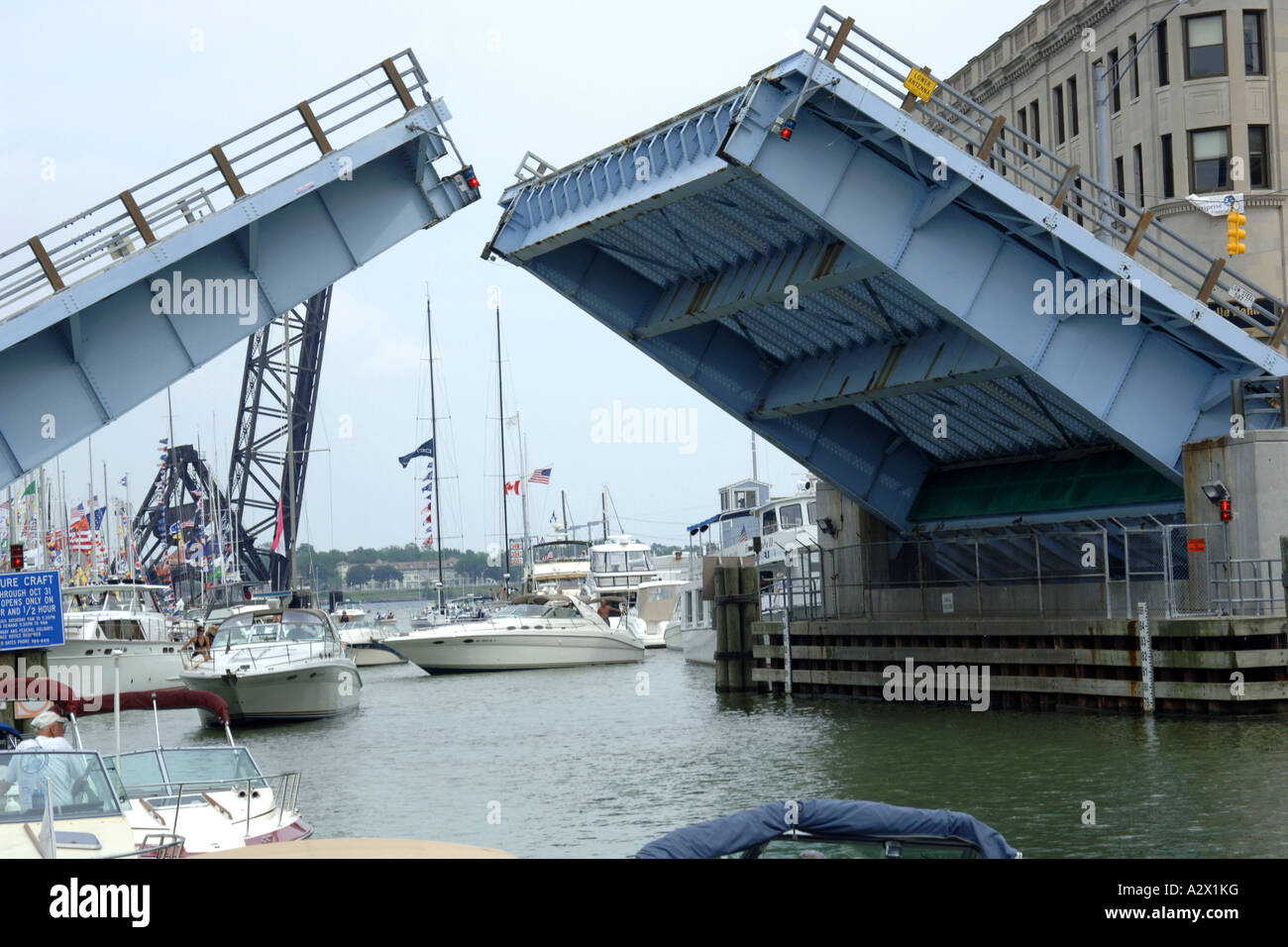 A drawbridge partially raised to let boats through Stock Photo - Alamy
