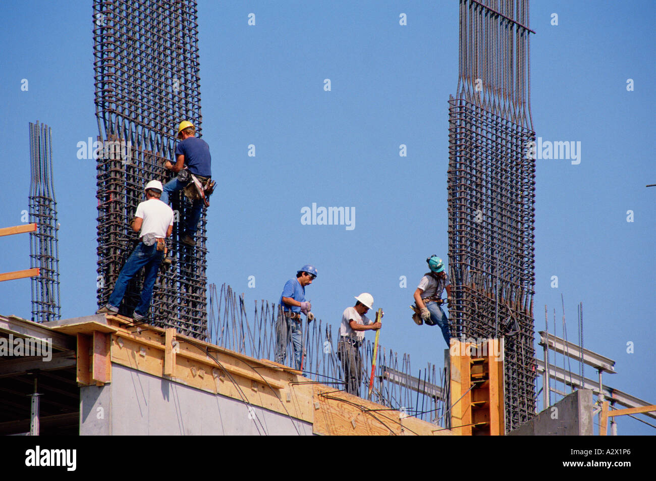 Construction site workers on high rise building Stock Photo - Alamy
