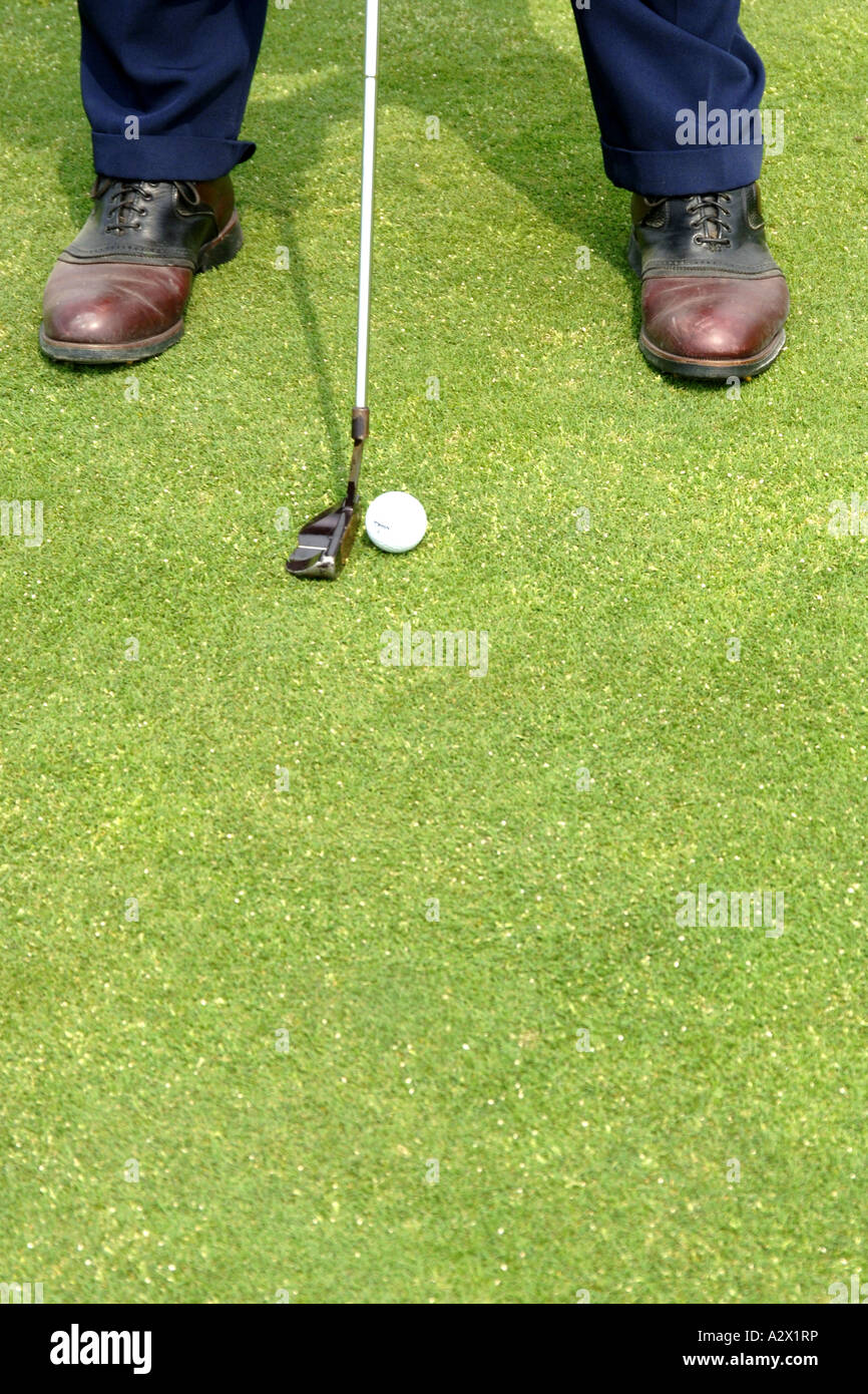Close up image of an adult male using a putter on a golf course Stock ...