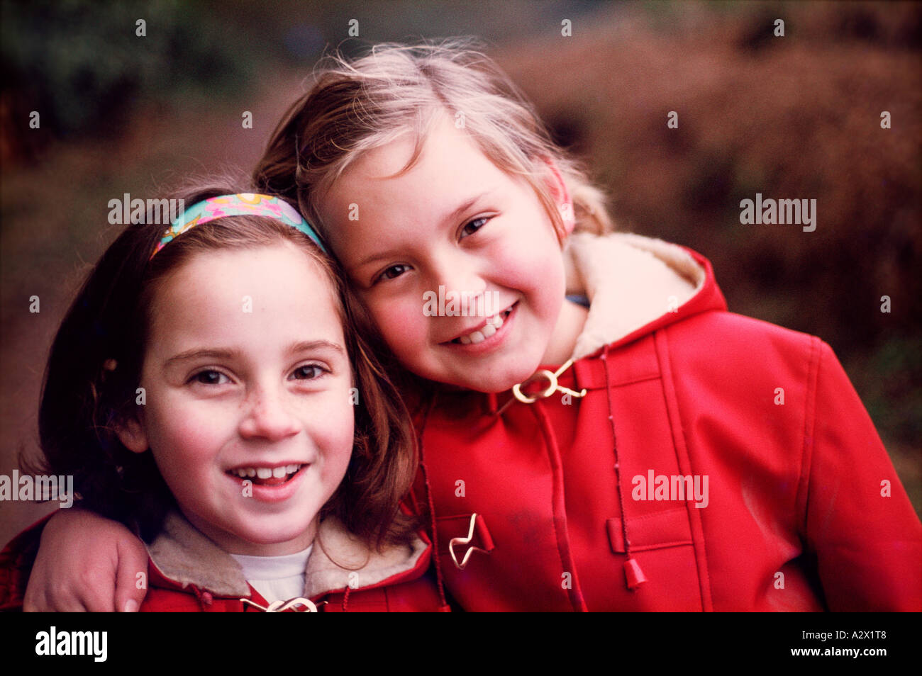 Two girls children hug smile hi-res stock photography and images - Alamy
