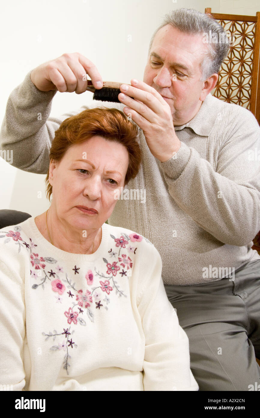 Husband cares for his sick ailing wife Stock Photo - Alamy