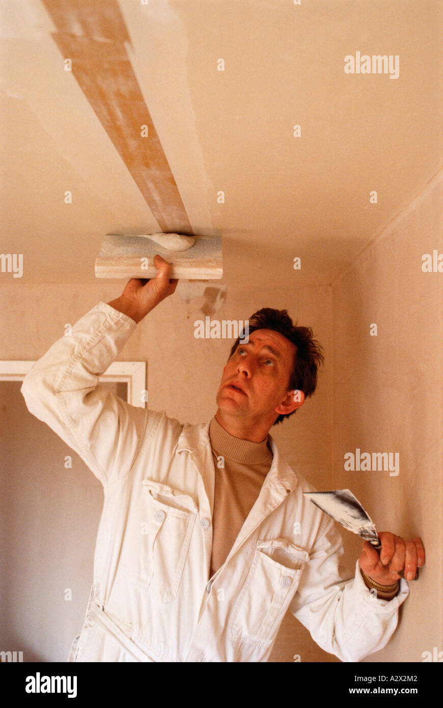 Man plastering a ceiling Stock Photo - Alamy