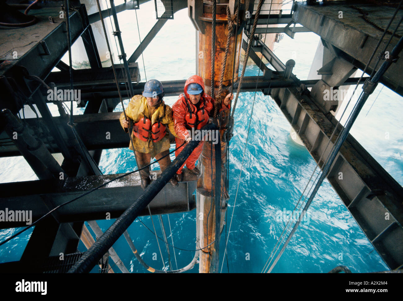 High viewpoint of two male engineers standing on oil drilling Stock ...