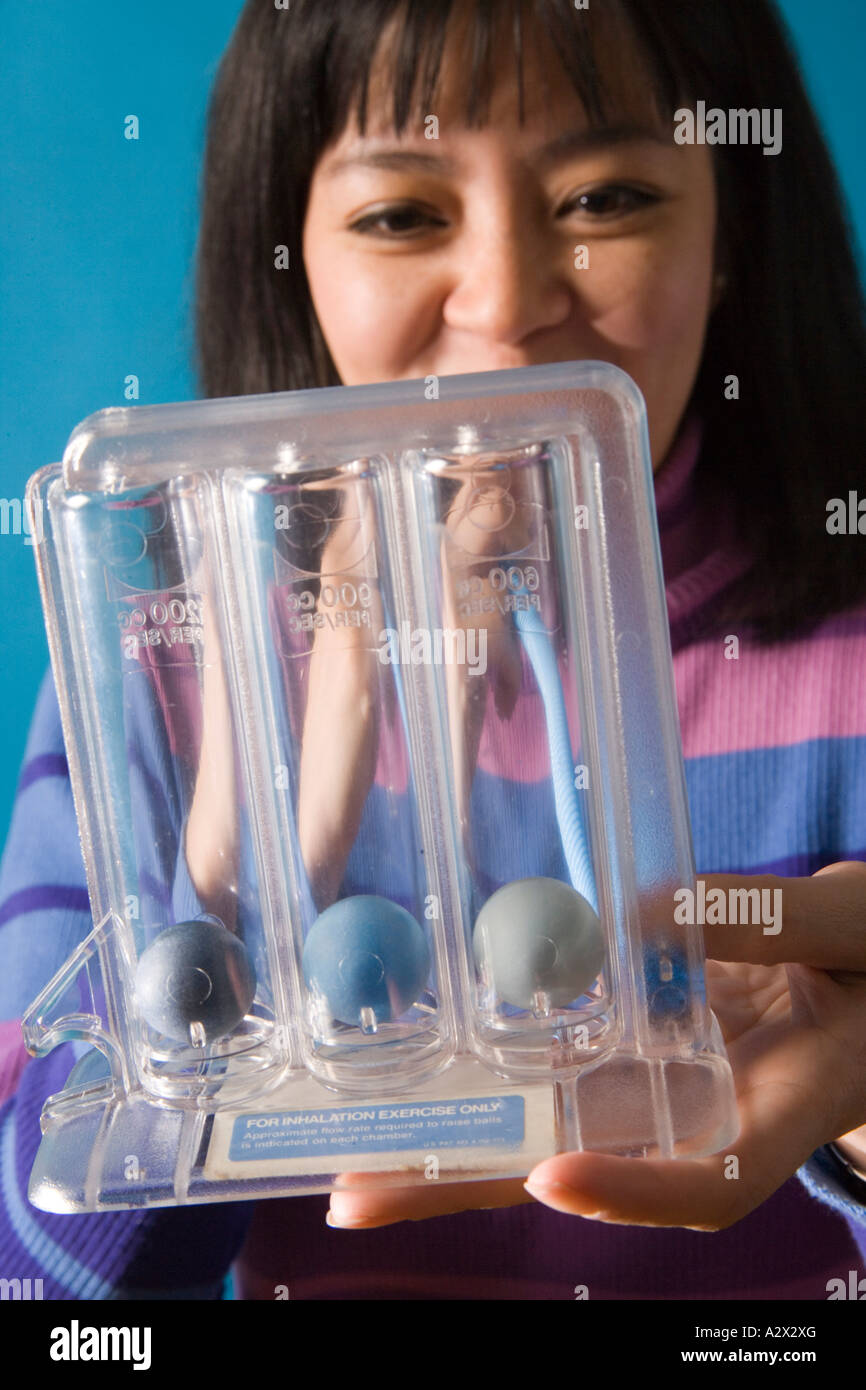 Young woman using a lung capacity pulmonary test Stock Photo - Alamy