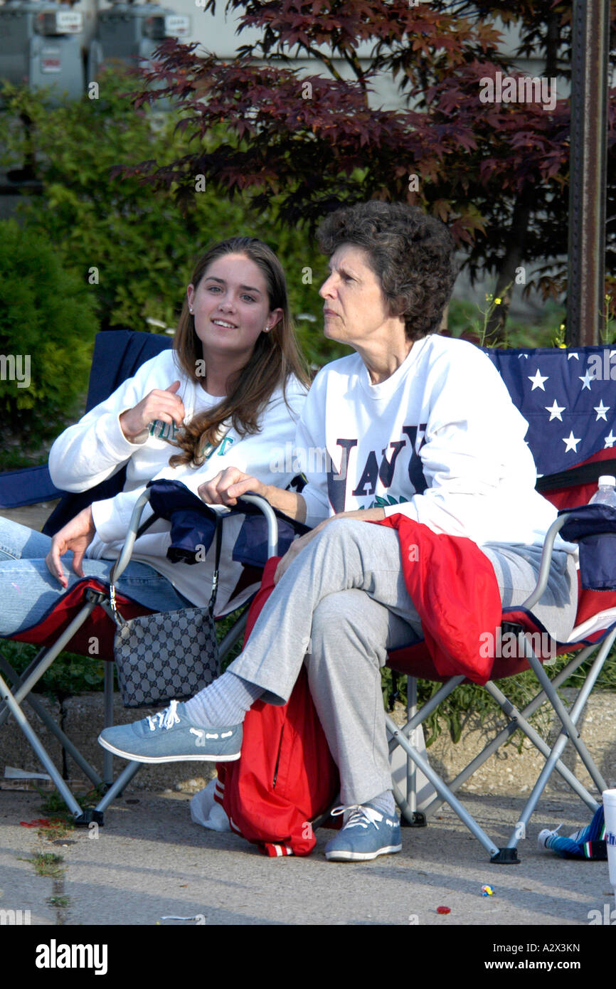 Spectators sitting on the sidewalk at a parade in Detroit Michigan MI ...