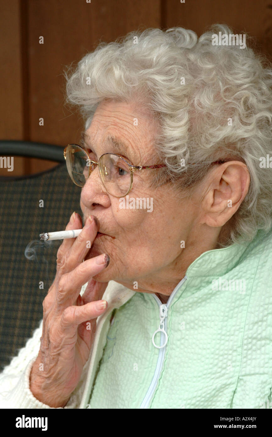 Senior female in her 80s enjoys smoking a cigarette Stock Photo - Alamy