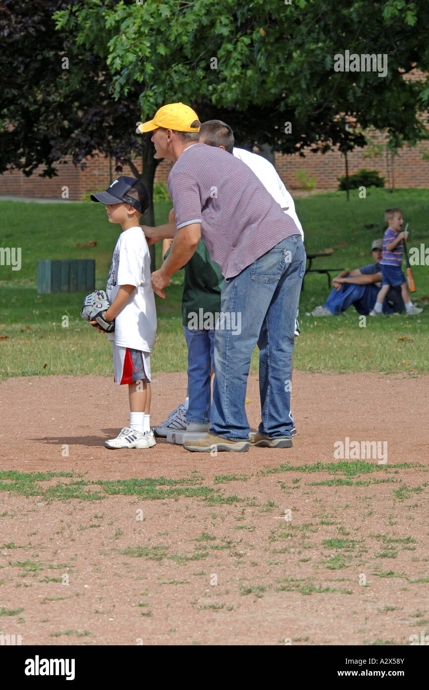 Young under-5 boy getting instructions from his father at a family T ...