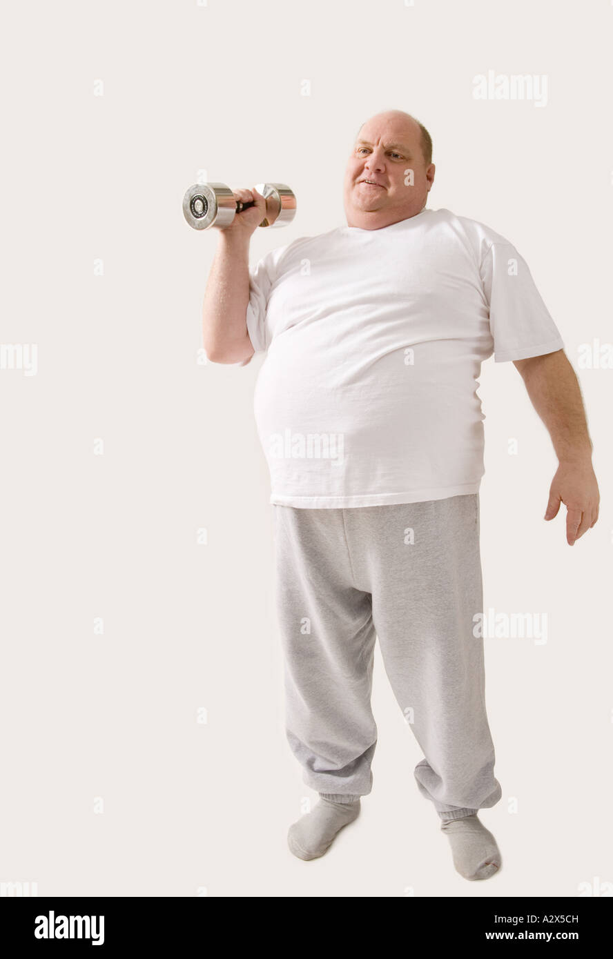 Overweight man exercising with weights Stock Photo - Alamy