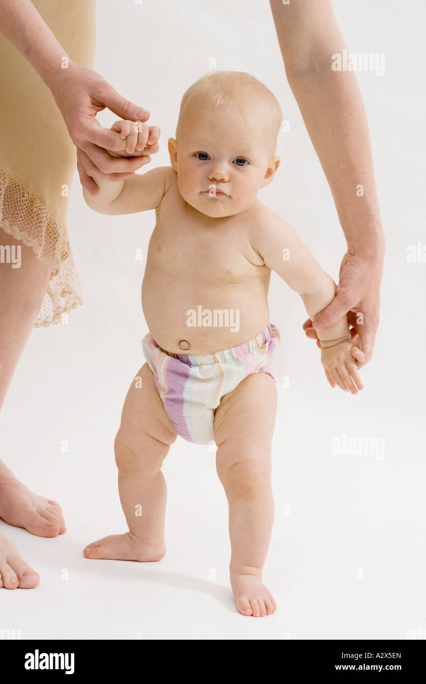 Baby practicing her first steps, no not yet. Baby is learning to ...