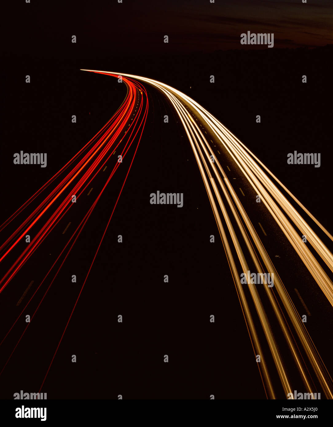 Light trails of two-way traffic on freeway at night Stock Photo - Alamy