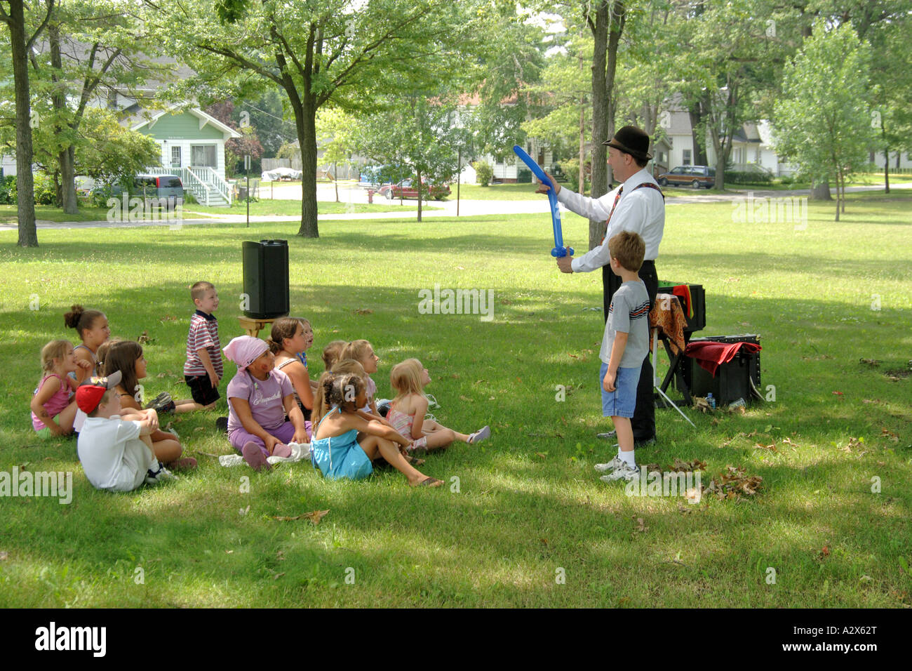Children being entertained by a magician in the Park on a summer's ...