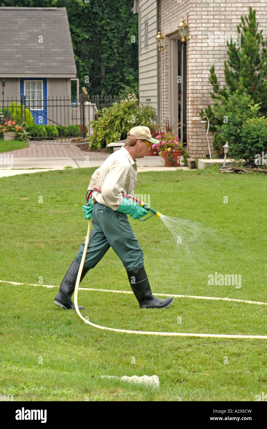 Professional Lawn care Maintenance man feeding a lawn with fertilizer ...