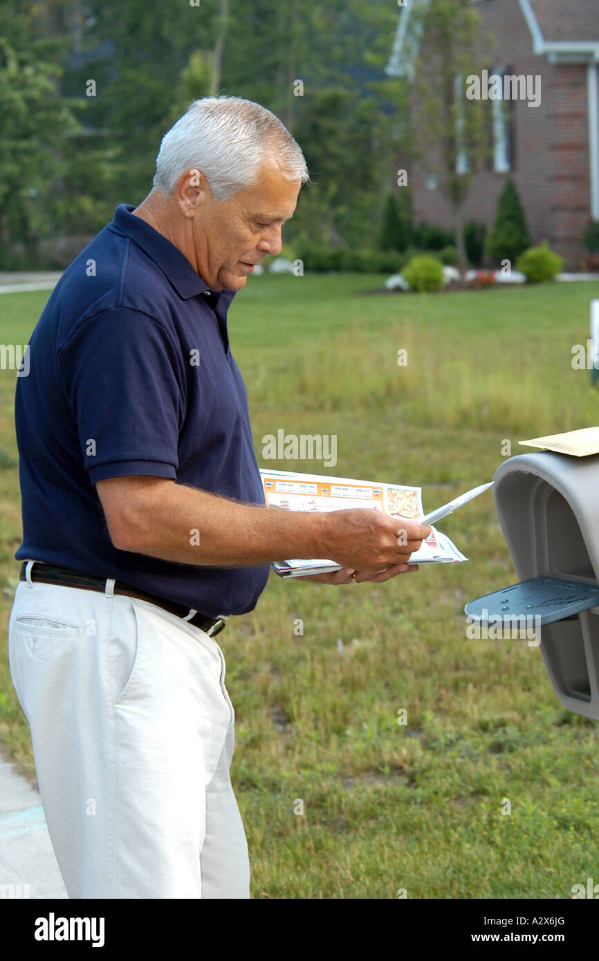 Collecting the usual junk mail from your postbox, this man checks ...