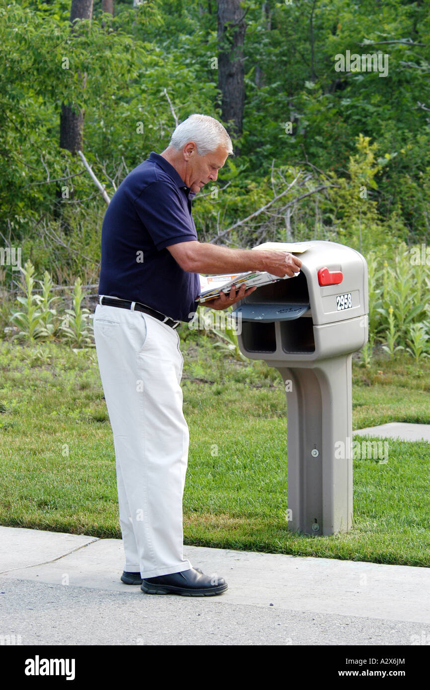 Collecting the usual junk mail from your postbox, this man checks ...
