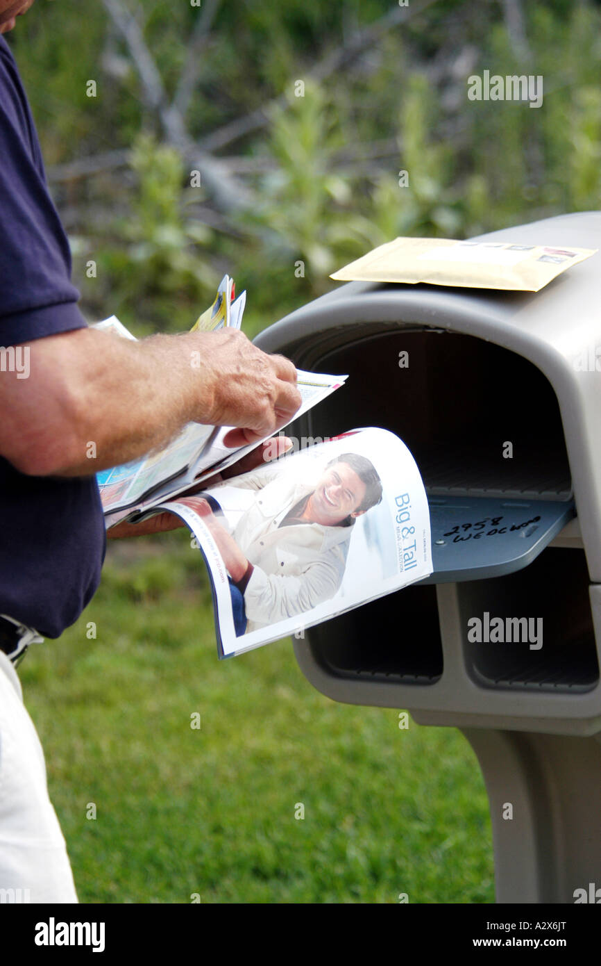 Collecting the usual junk mail from your postbox, this man checks ...