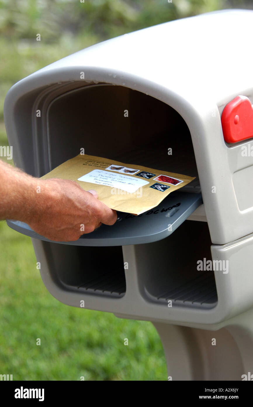 Placing a letter in the mail box for collection by the US Postal ...